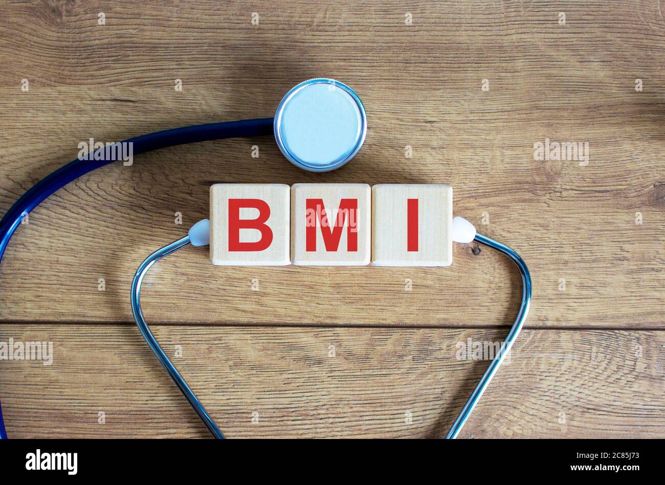 Medical concept. Wooden cubes with the inscription BMI and stethoscope ...