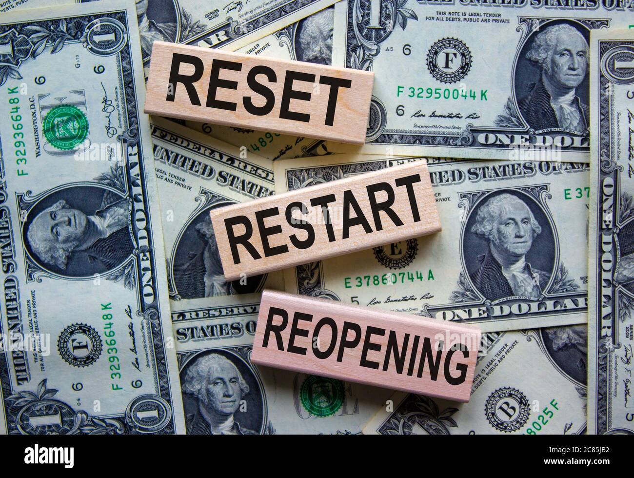 Concept words 'reset, restart, reopening' on wooden blocks on a ...