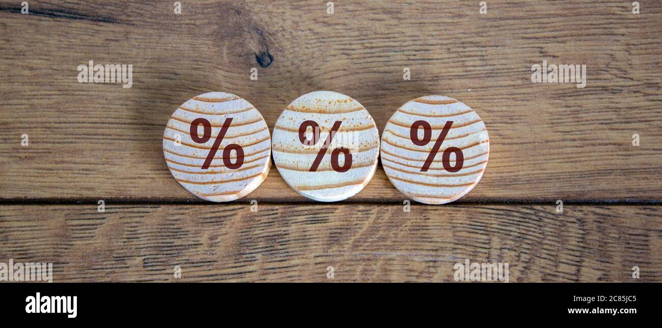 Percent sign. Wooden small circles with on wood background. Concept ...