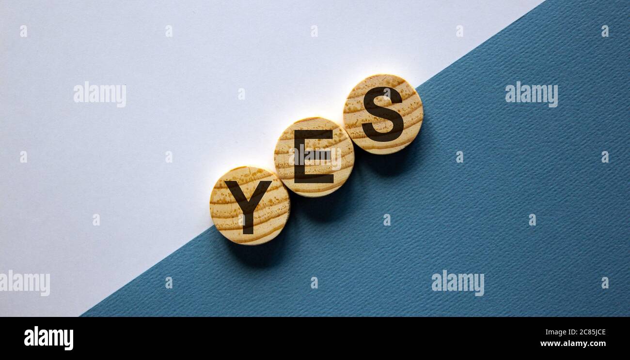 Wood circles with word 'yes' stacking as step stair on paper white and ...