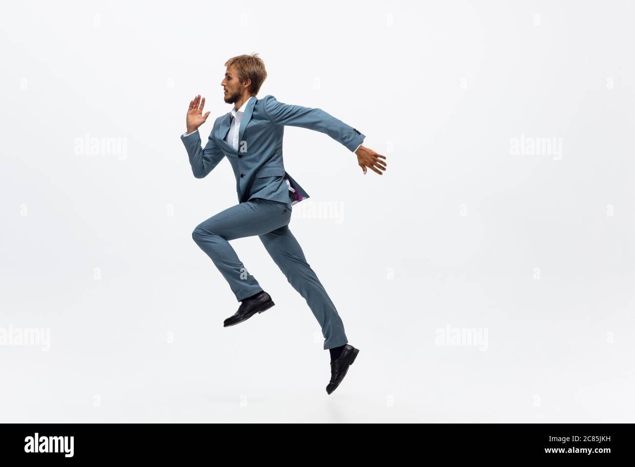Start up. Man in office clothes running, jogging on white background ...