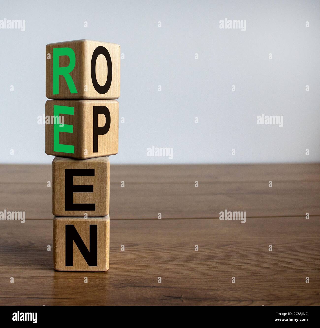 Concept word 'reopen' on cubes on a beautiful wooden table. White ...