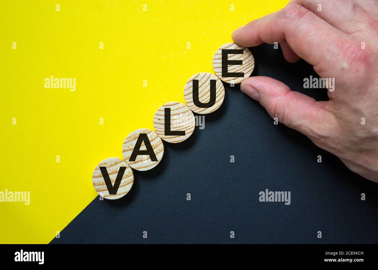 Wood circles with word 'value' stacking as step stair on paper yellow ...