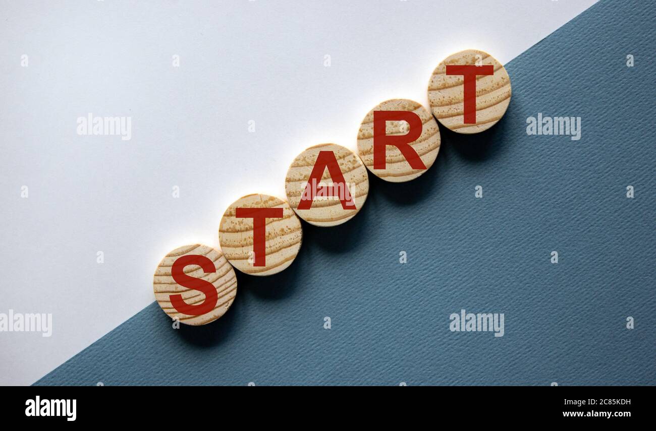Wood circles with word 'start' on paper blue and white background, copy ...