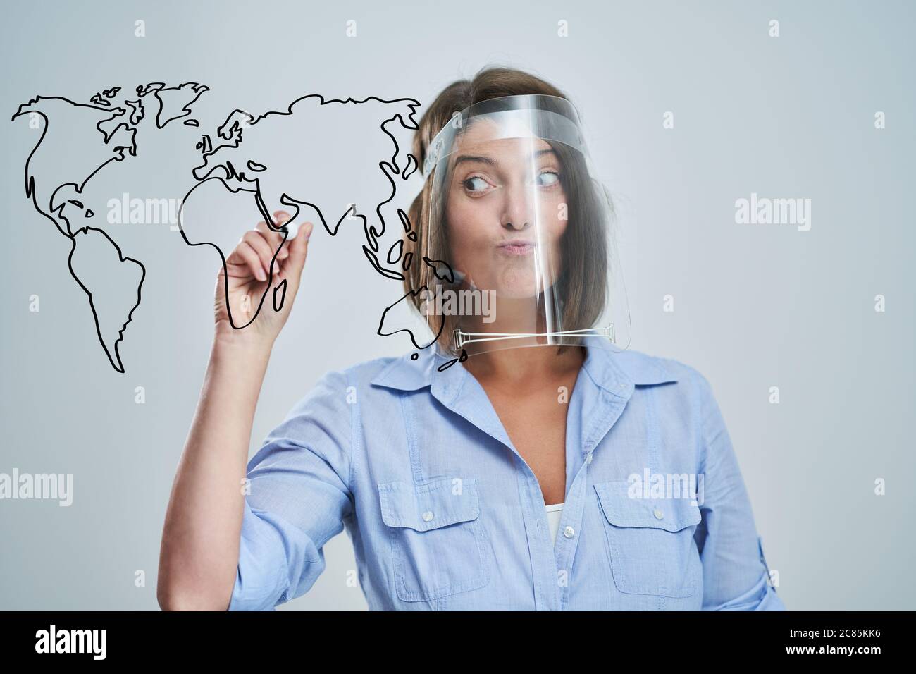 Attractive woman wearing protective shield writing over white ...