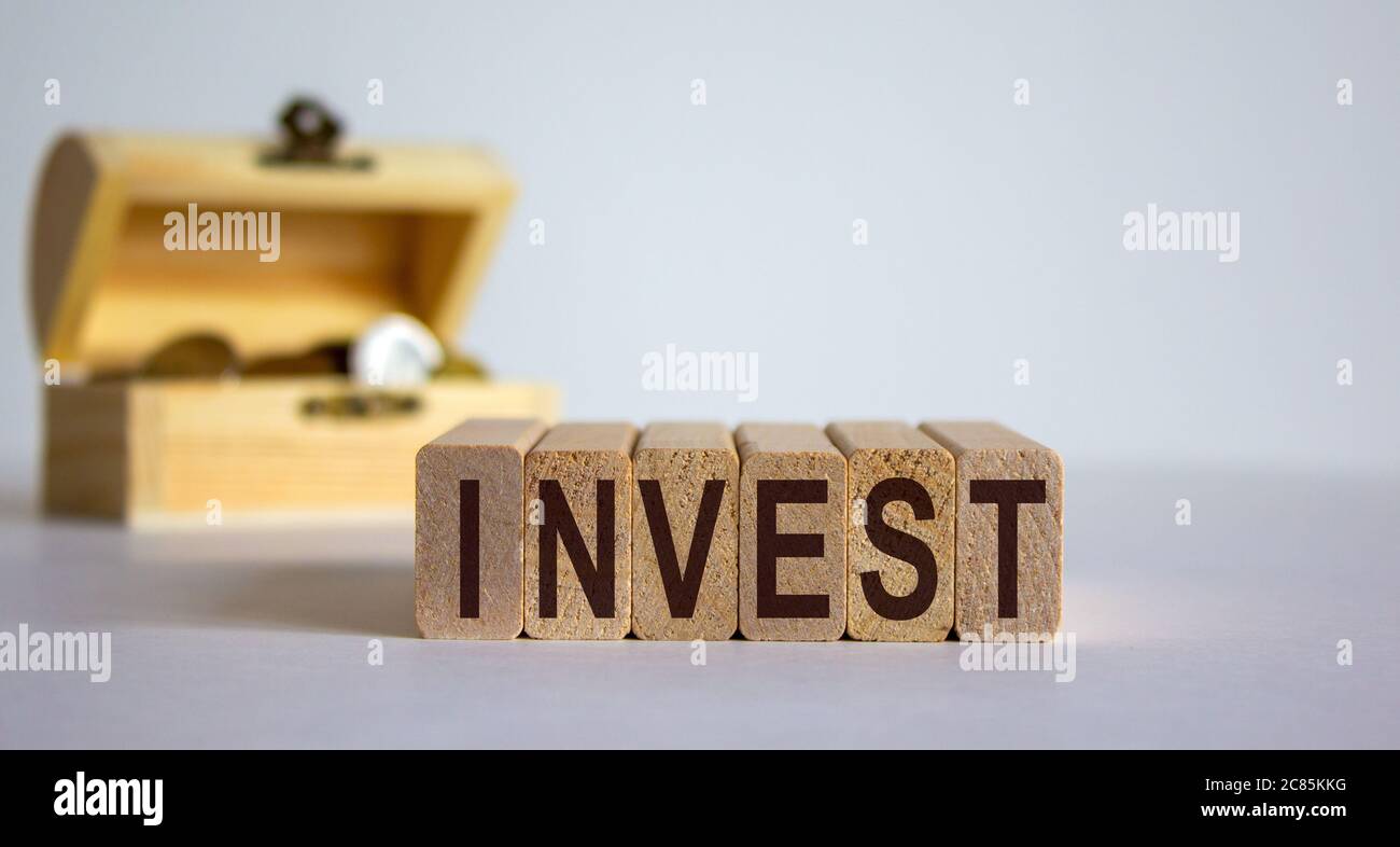 Concept word invest on cubes on a beautiful white background, small ...
