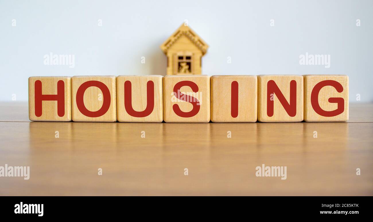 Blocks form the word housing in front of a miniature house Stock Photo ...