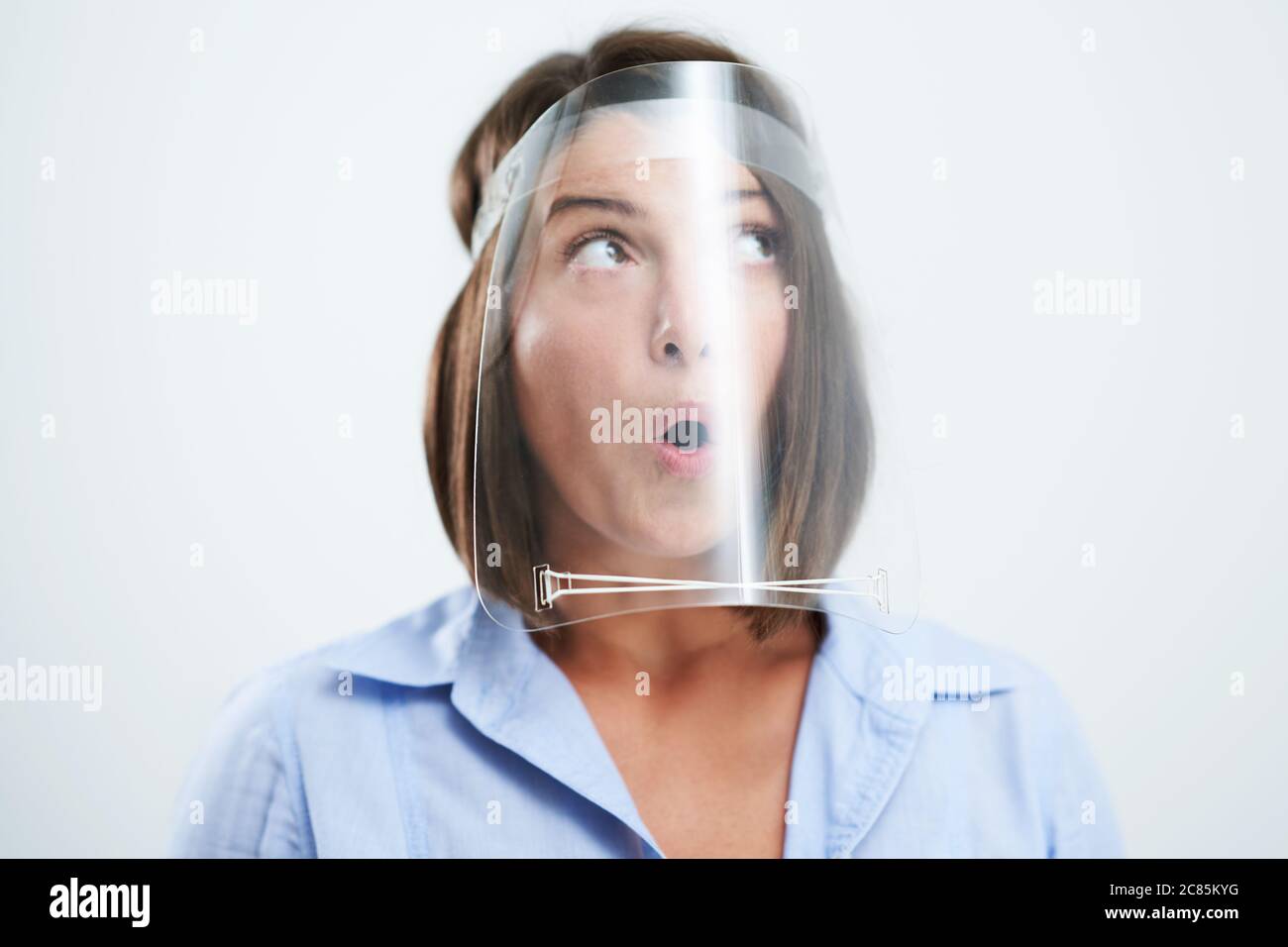 Attractive woman wearing protective shield isolated over white ...