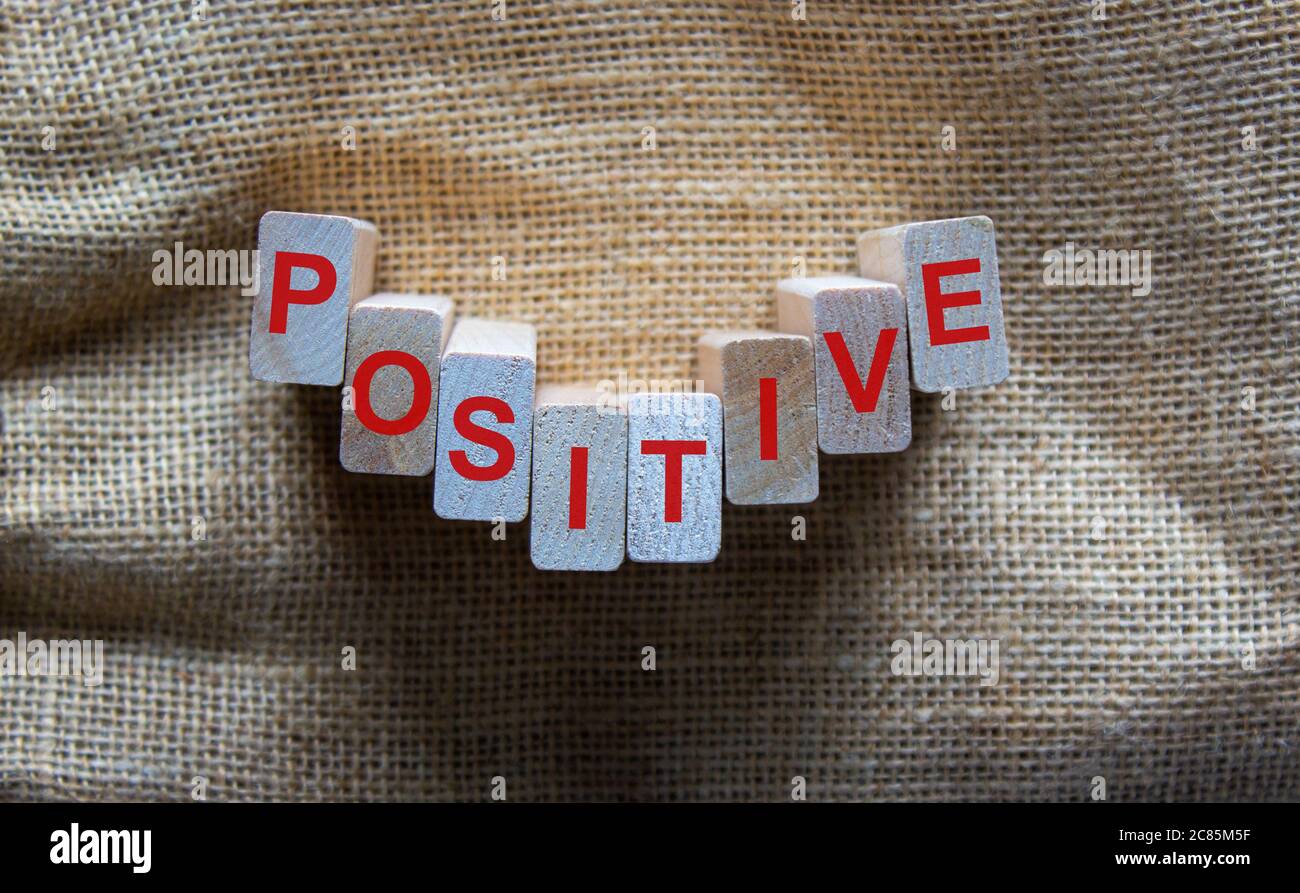 Wooden block form the text 'positive' on beautiful canvas background ...