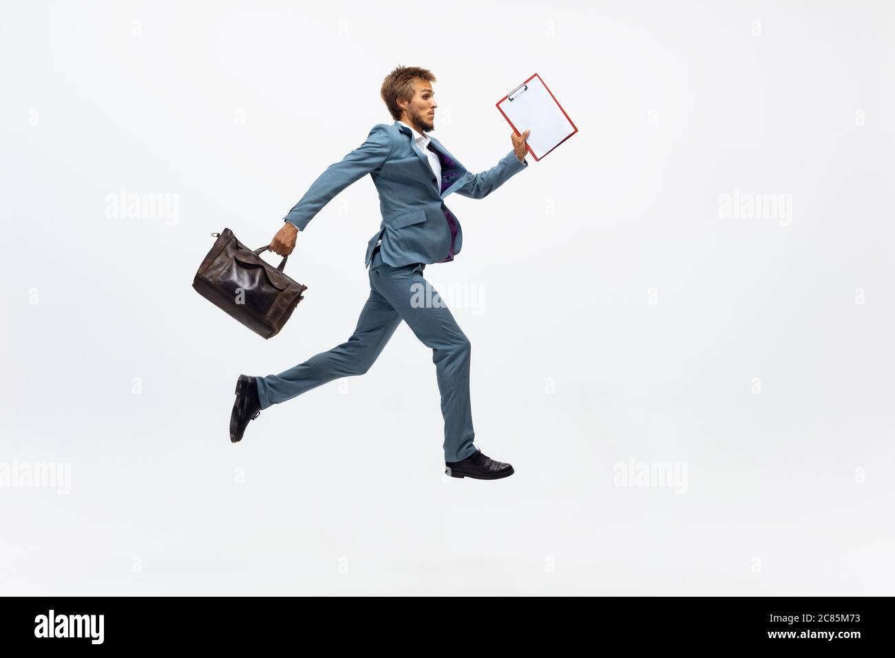 Successful. Man in office clothes running, jogging on white background ...