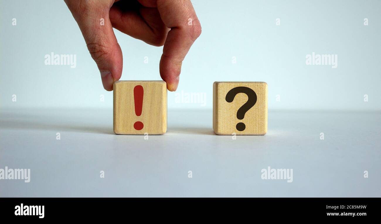 Hand making a choice between two cubes with exclamation mark and ...