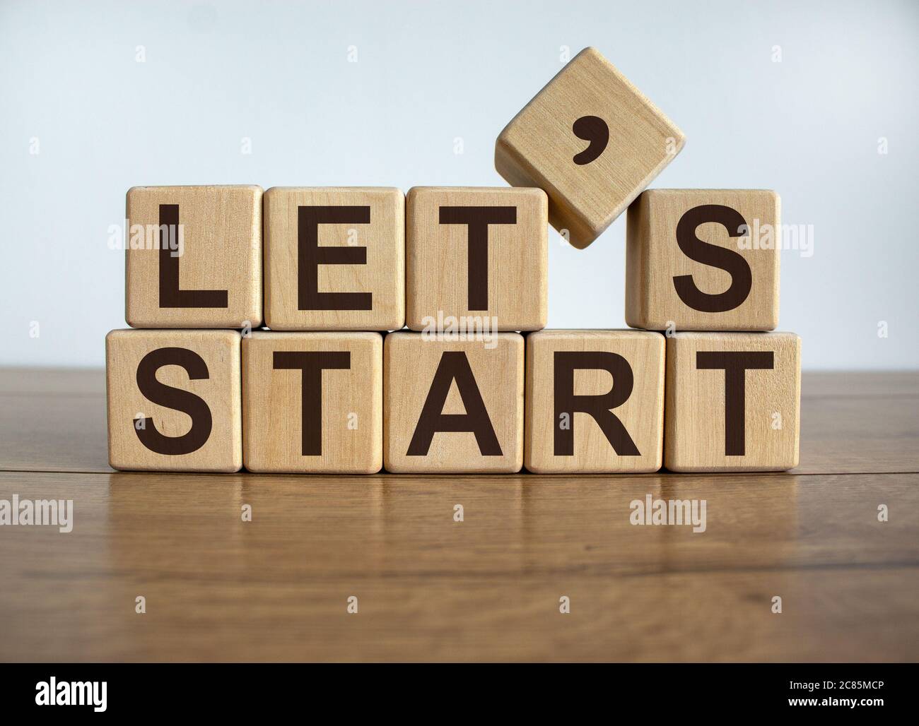Concept word 'lets start' on cubes on a beautiful wooden background ... Concept word 'lets start' on cubes on a beautiful wooden background ...