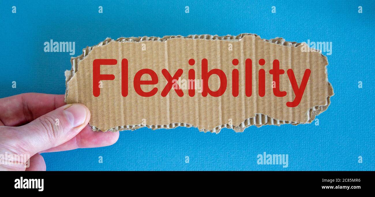 Word 'flexibility' on the piece of cardboard between fingers Stock ...