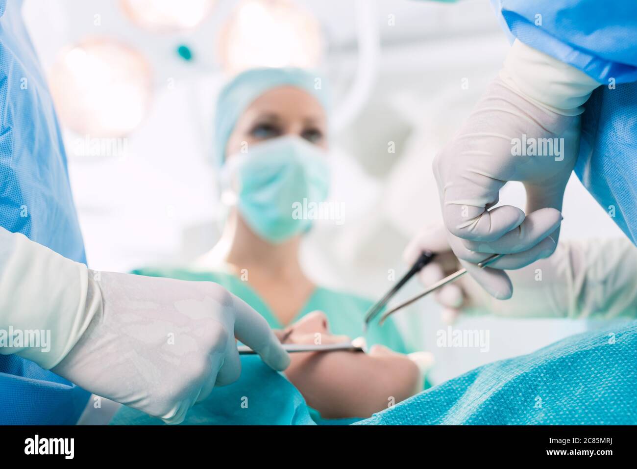 Surgeons operating patient in operation theater Stock Photo - Alamy