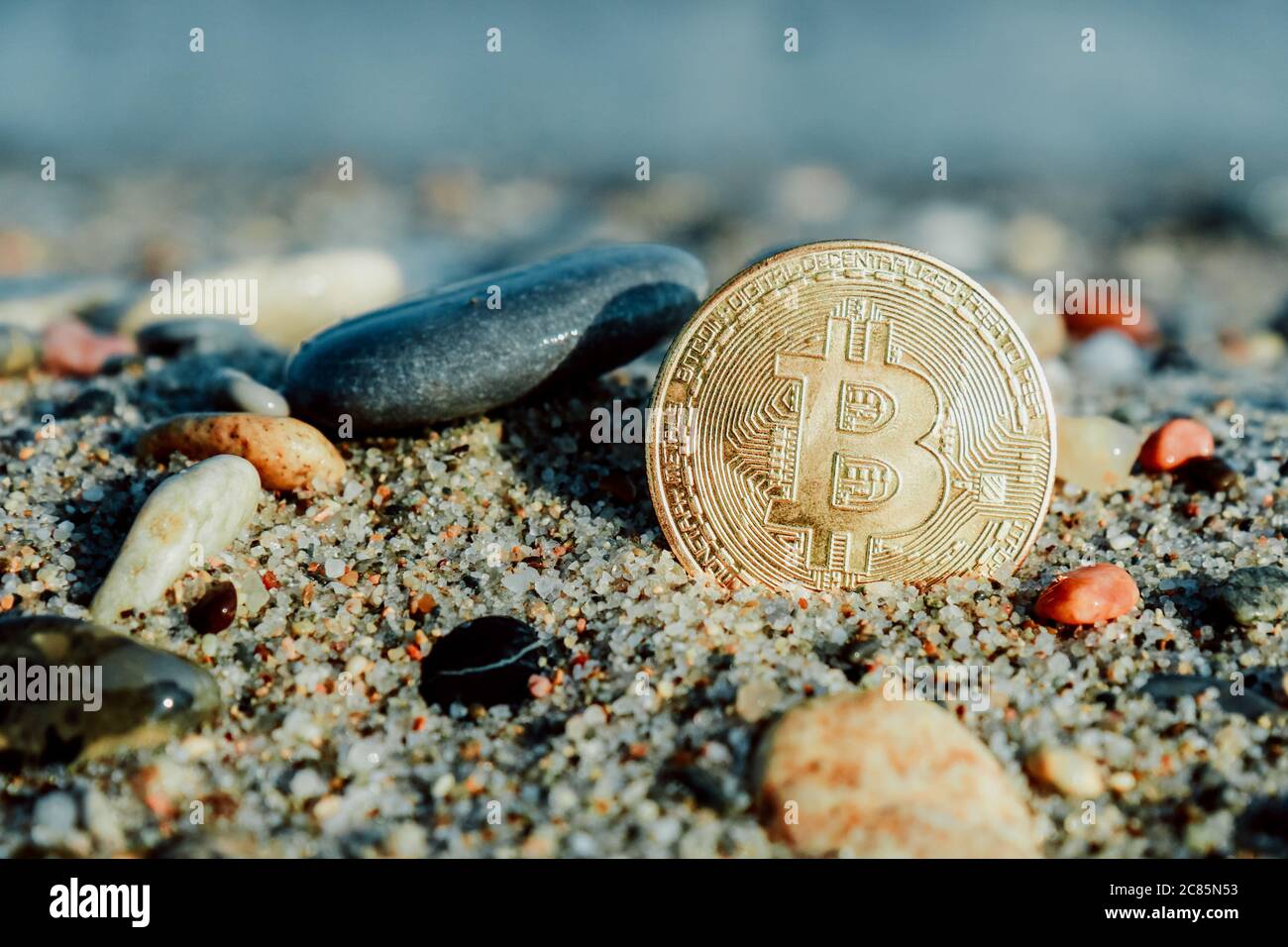 Bitcoin virtual currency on the beach Stock Photo - Alamy