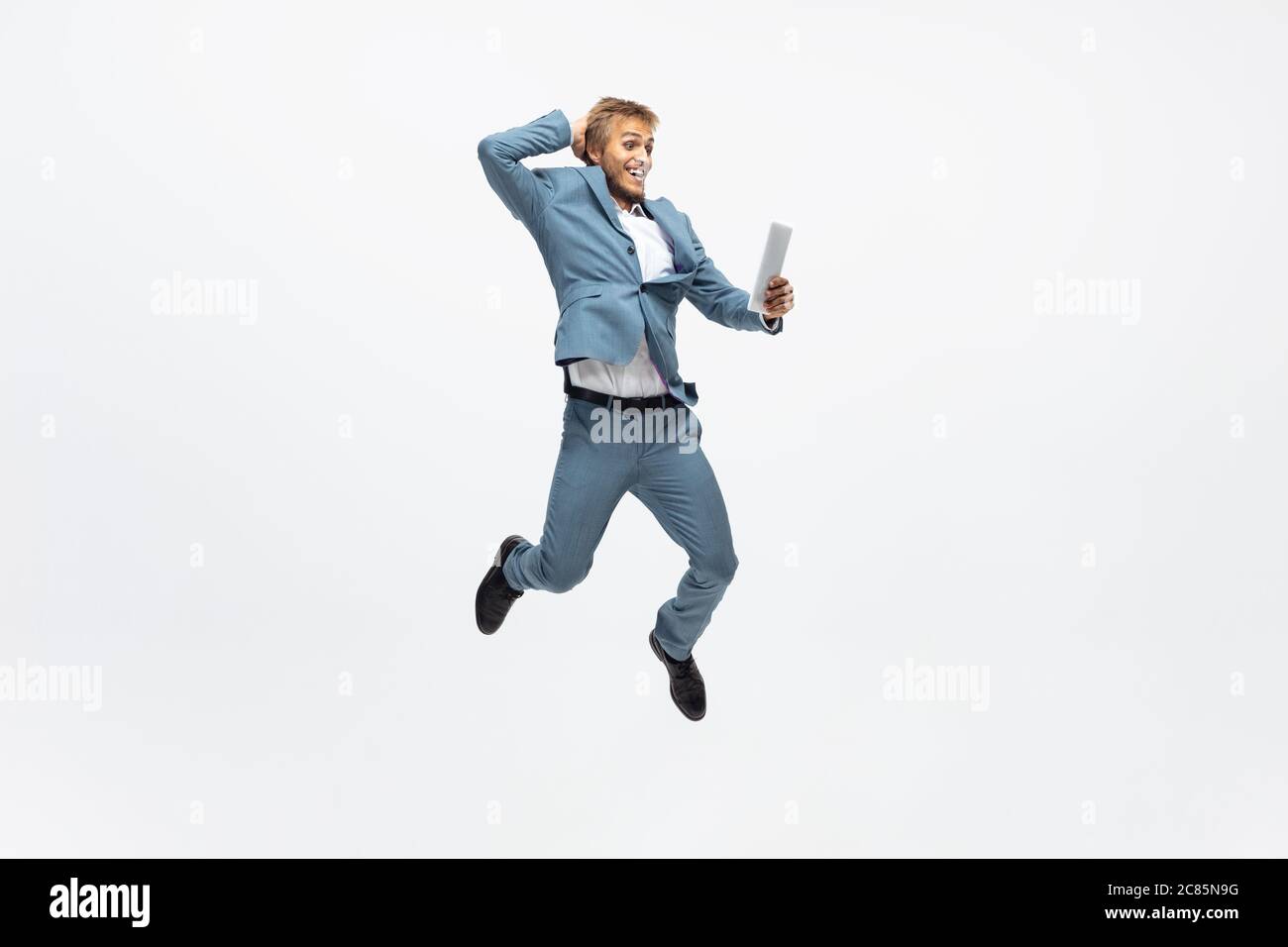 Winner, jump. Man in office clothes running, jogging on white ...