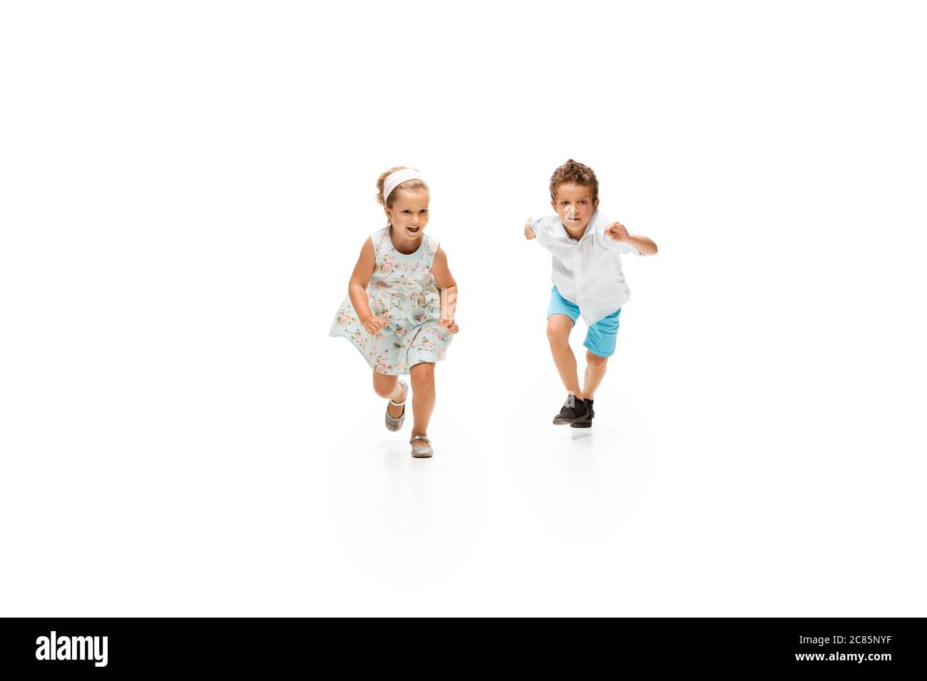 Happy children, little and emotional caucasian boy and girl jumping and ...