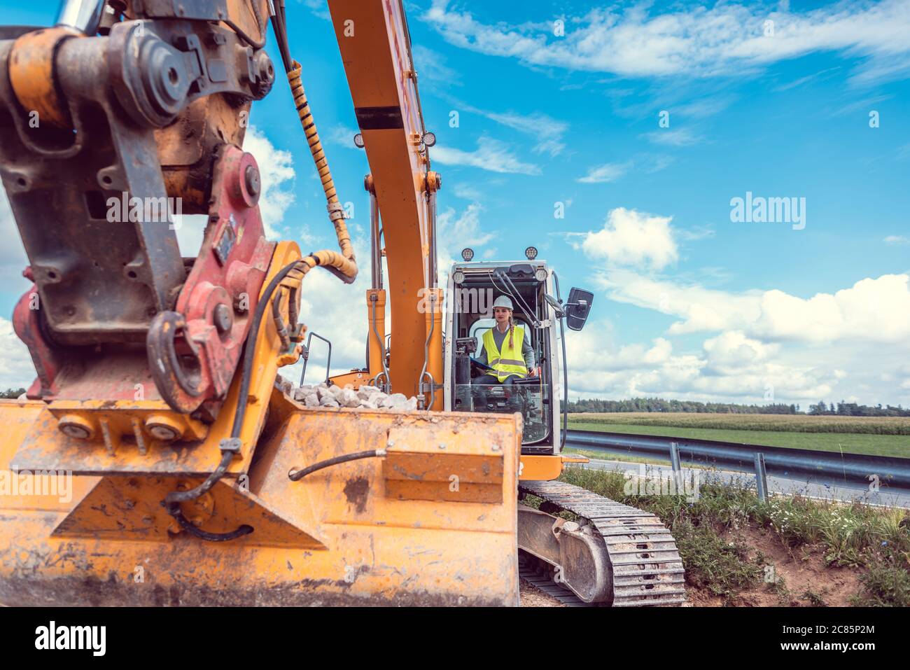 Woman construction worker with excavator on sit Stock Photo - Alamy