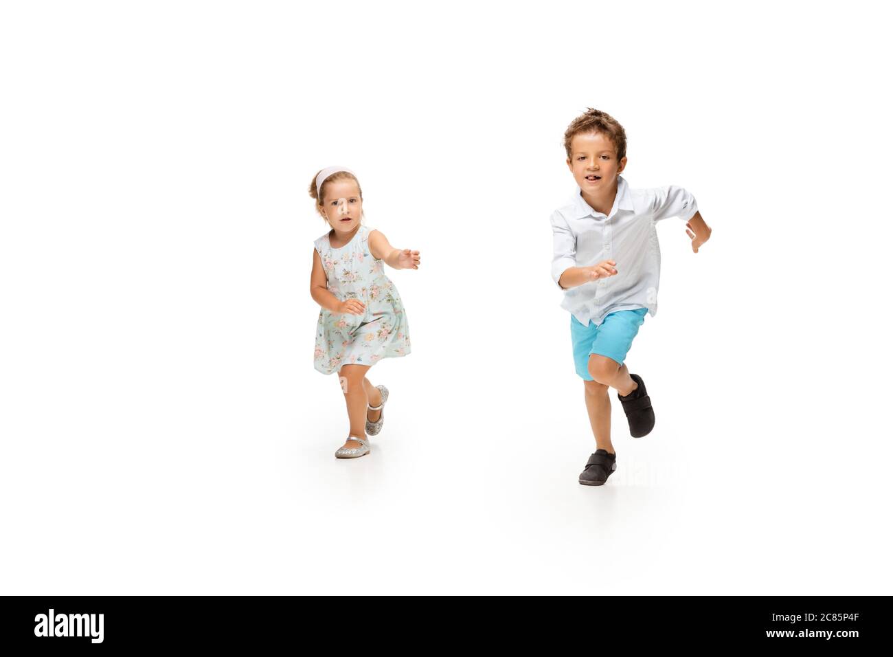 Happy children, little and emotional caucasian boy and girl jumping and ...