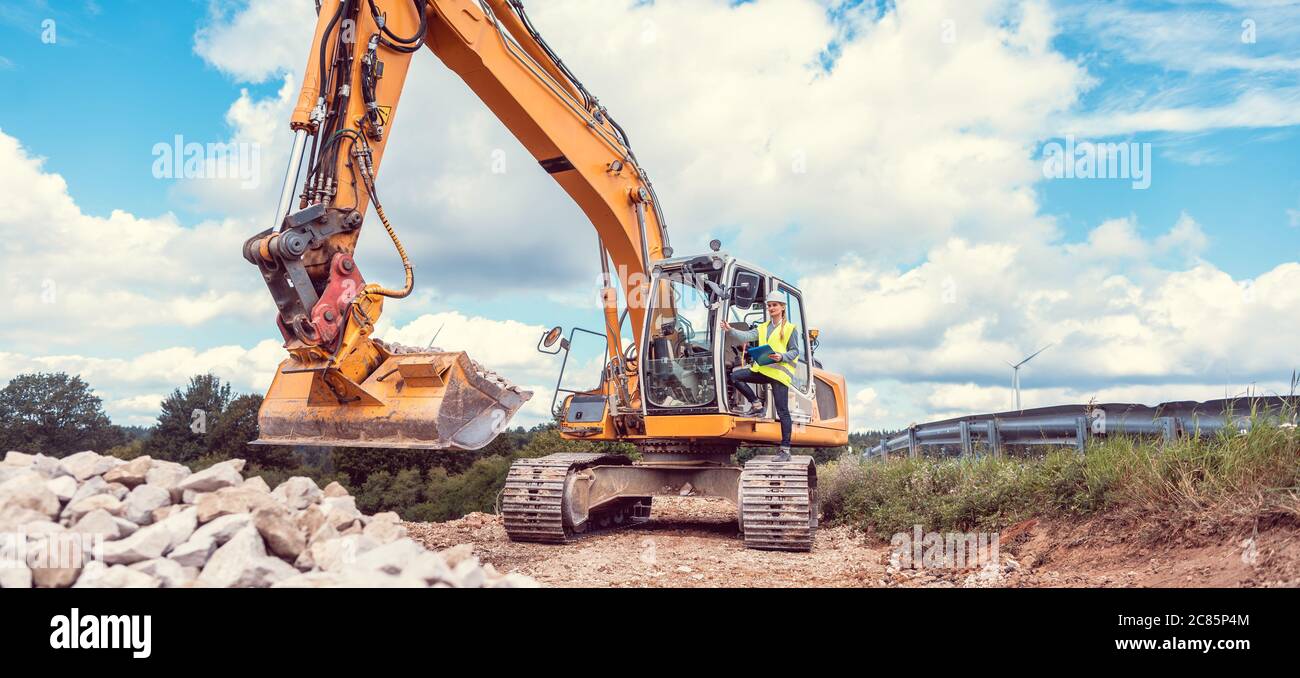 Woman construction worker with excavator on sit Stock Photo - Alamy