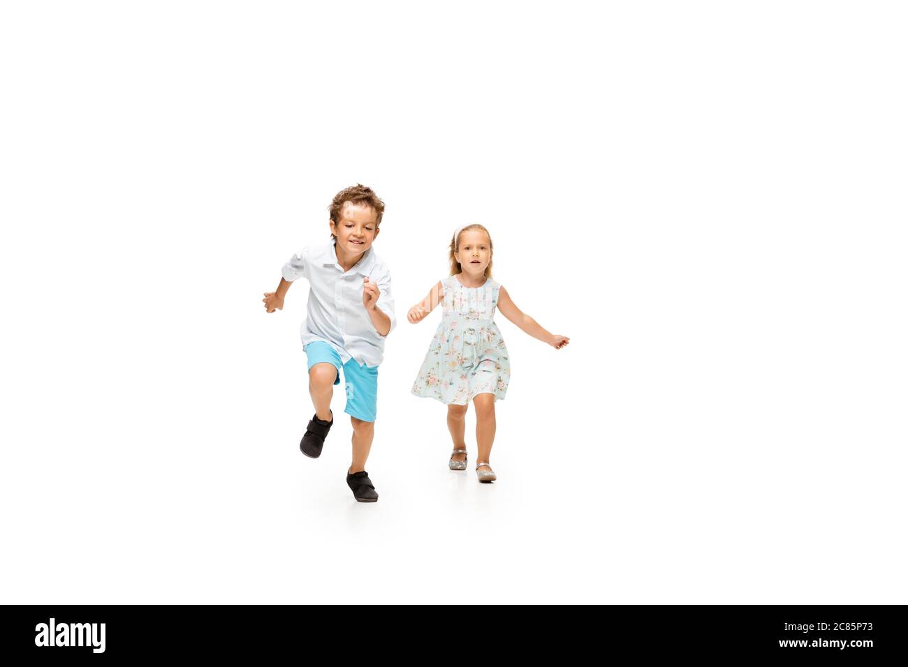 Happy children, little and emotional caucasian boy and girl jumping and ...