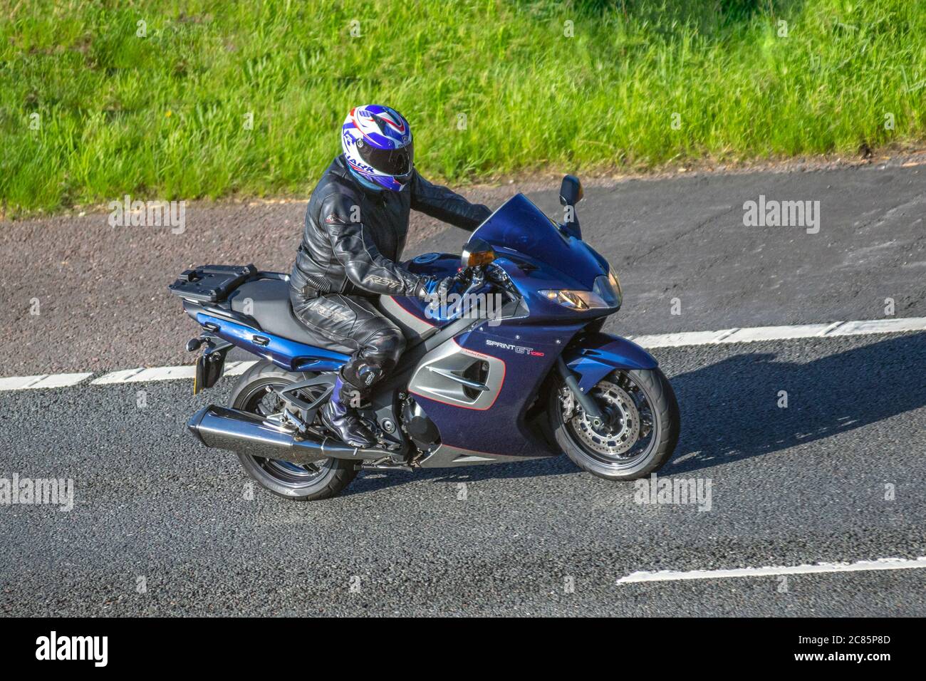 Blue Triumph Sprint GT Limited Edition; Motorbike rider; two wheeled ...