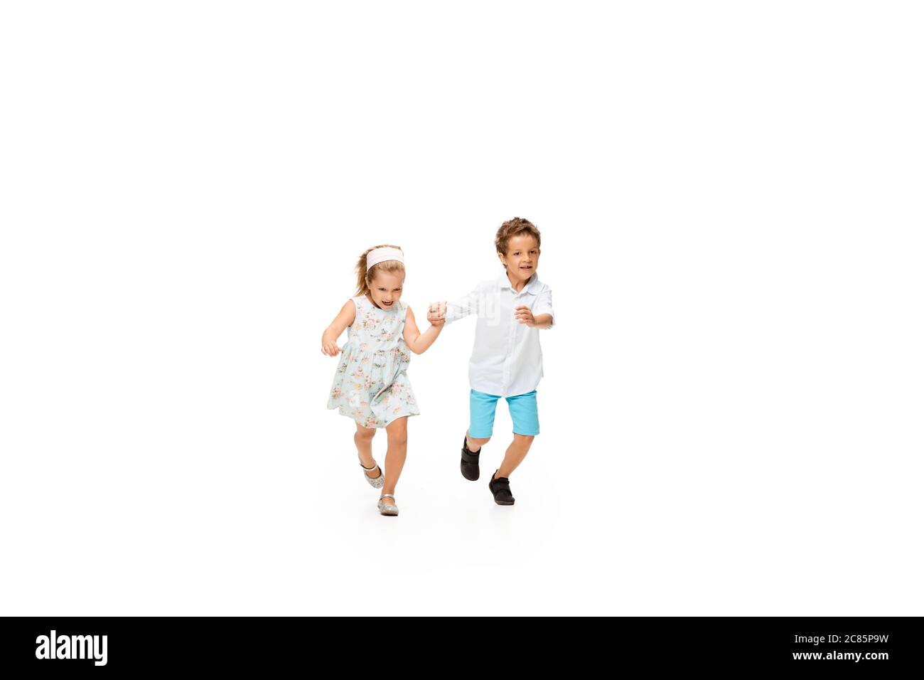 Happy children, little and emotional caucasian boy and girl jumping and ...