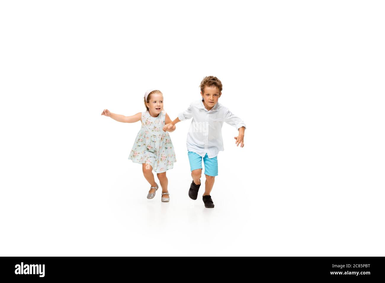 Happy children, little and emotional caucasian boy and girl jumping and ...