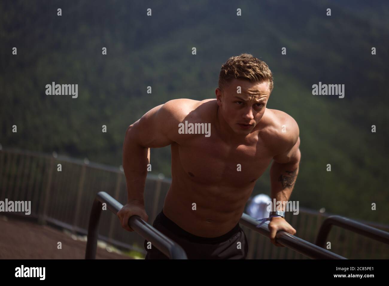 young blonde male athlete with focused and tensed face expression ...