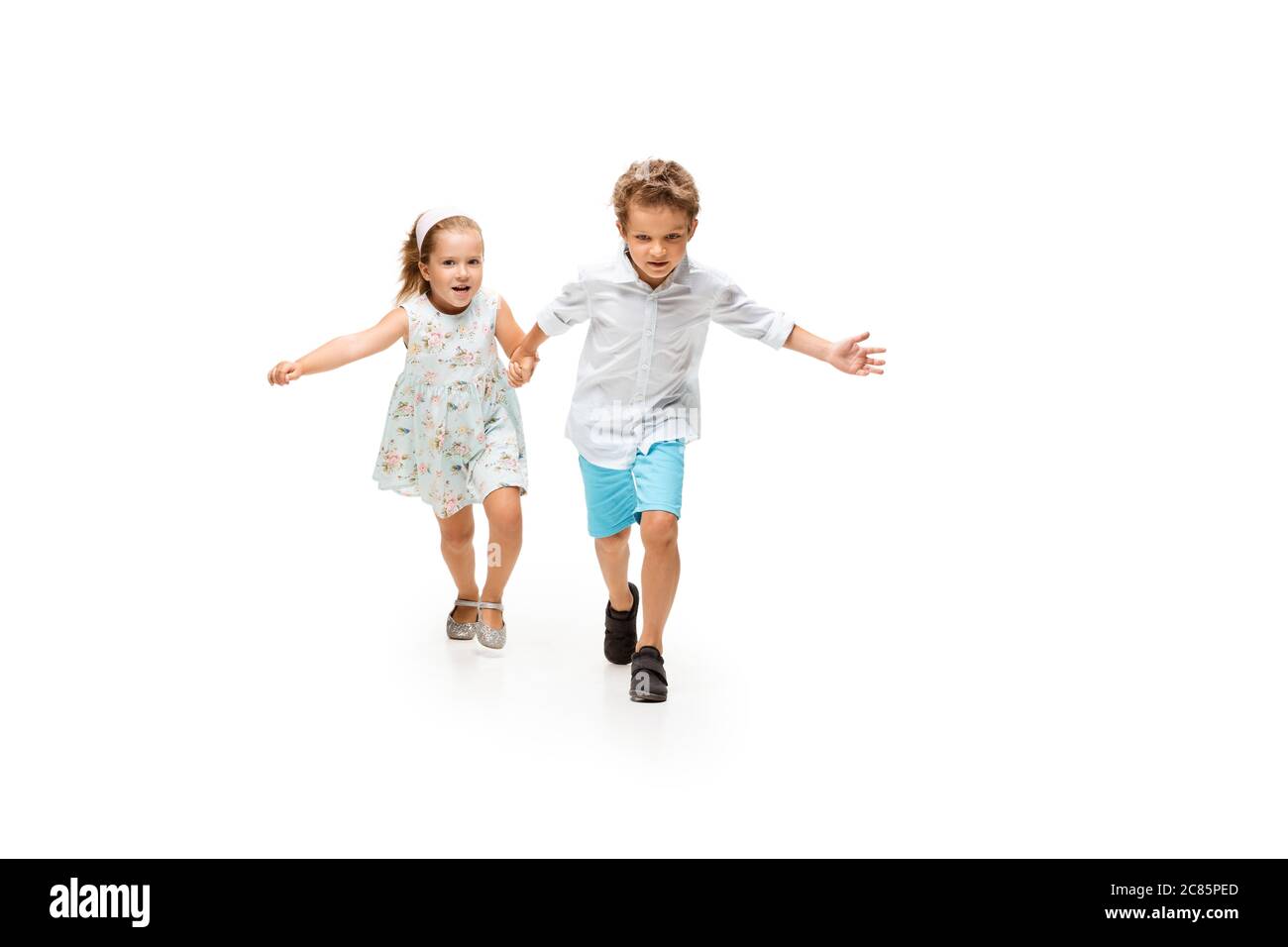 Happy children, little and emotional caucasian boy and girl jumping and ...