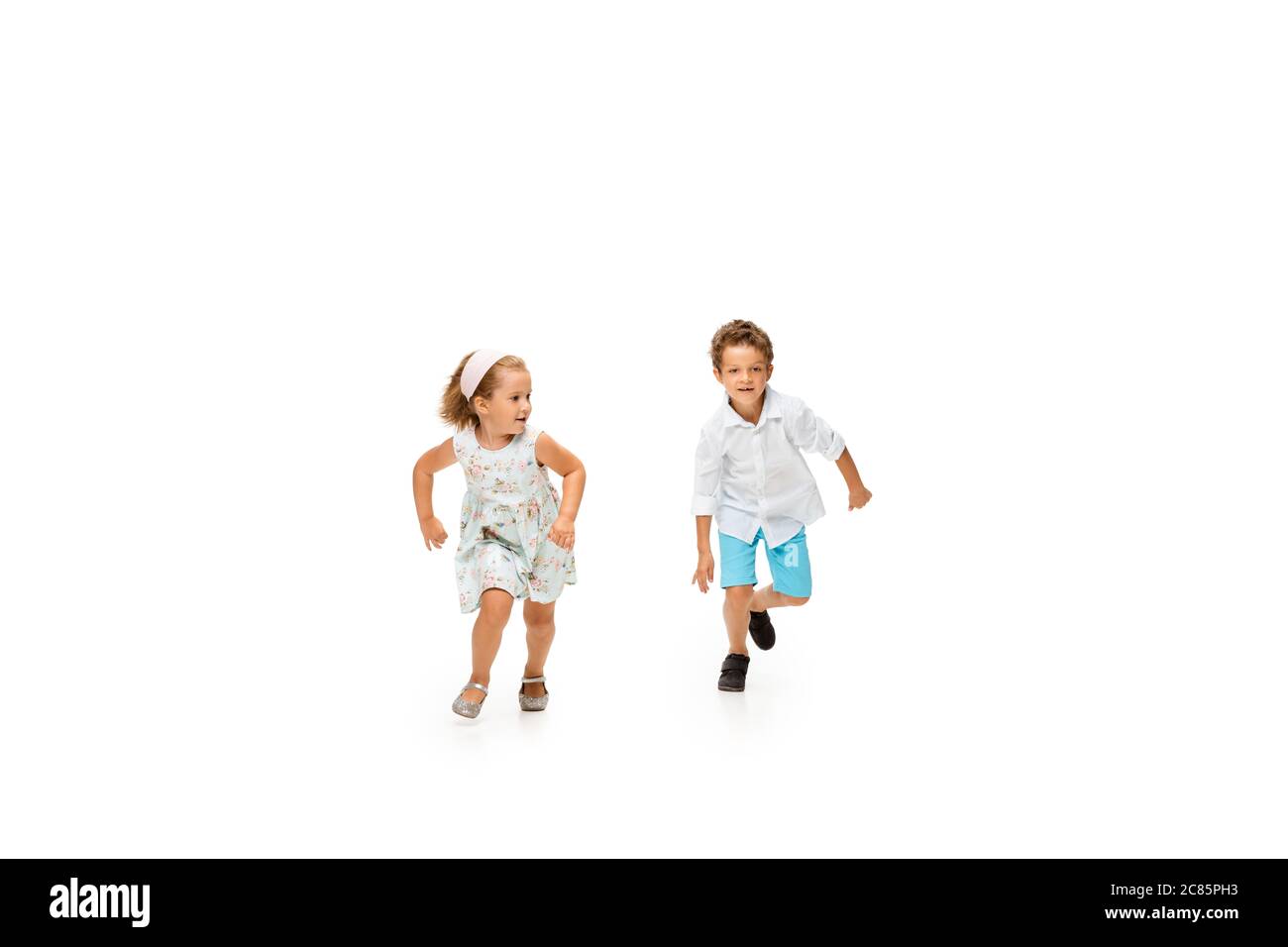 Happy children, little and emotional caucasian boy and girl jumping and ...