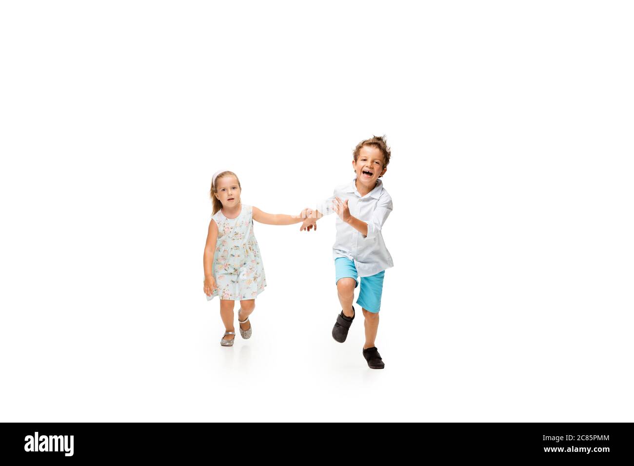 Happy children, little and emotional caucasian boy and girl jumping and ...