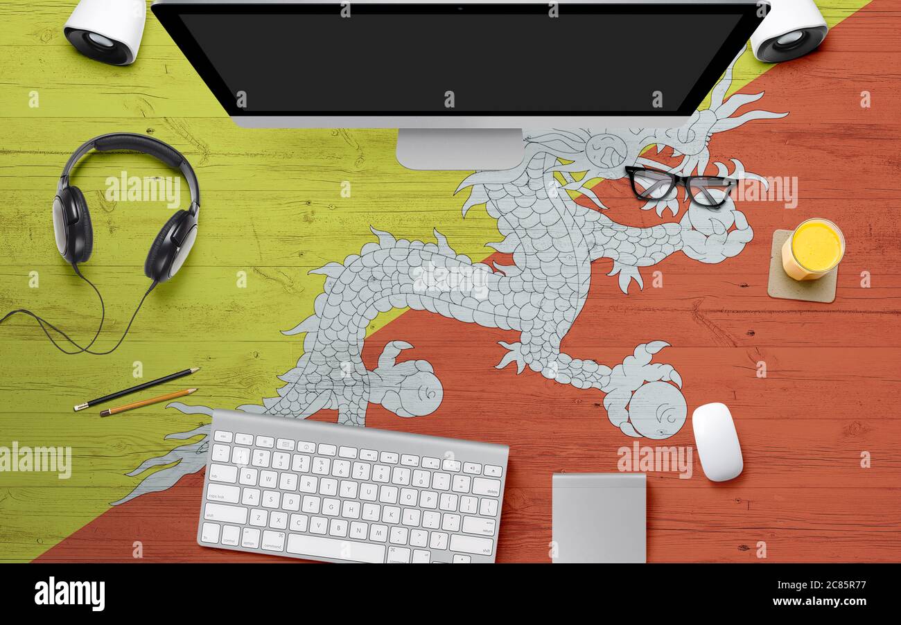Bhutan flag background with headphone,computer keyboard and mouse on ...