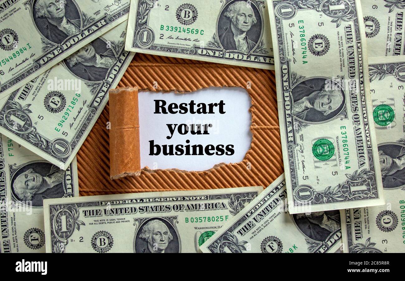 The text 'restart your business' appearing behind torn brown paper ...