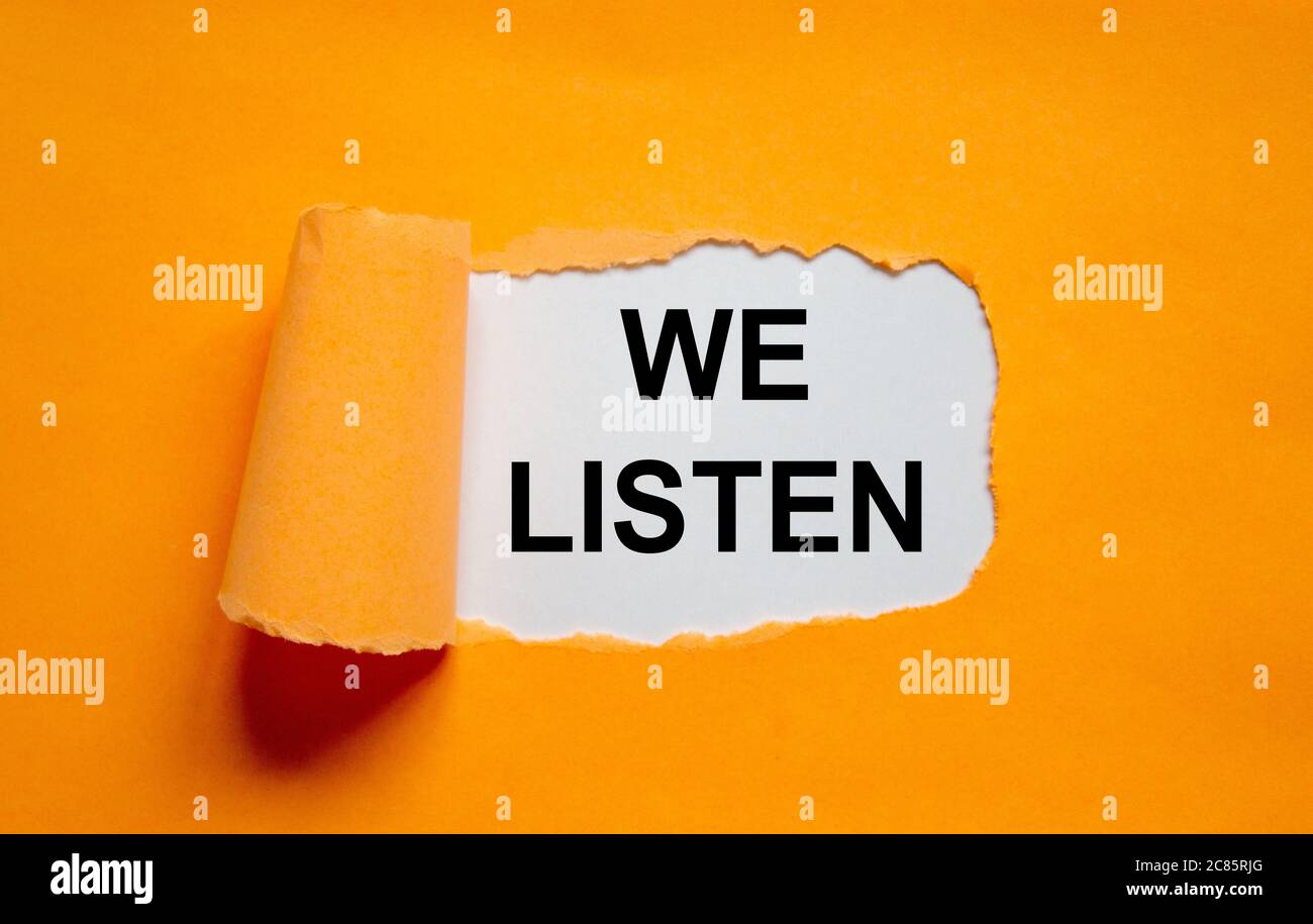 The text 'we listen' appearing behind torn orange paper. Business ...