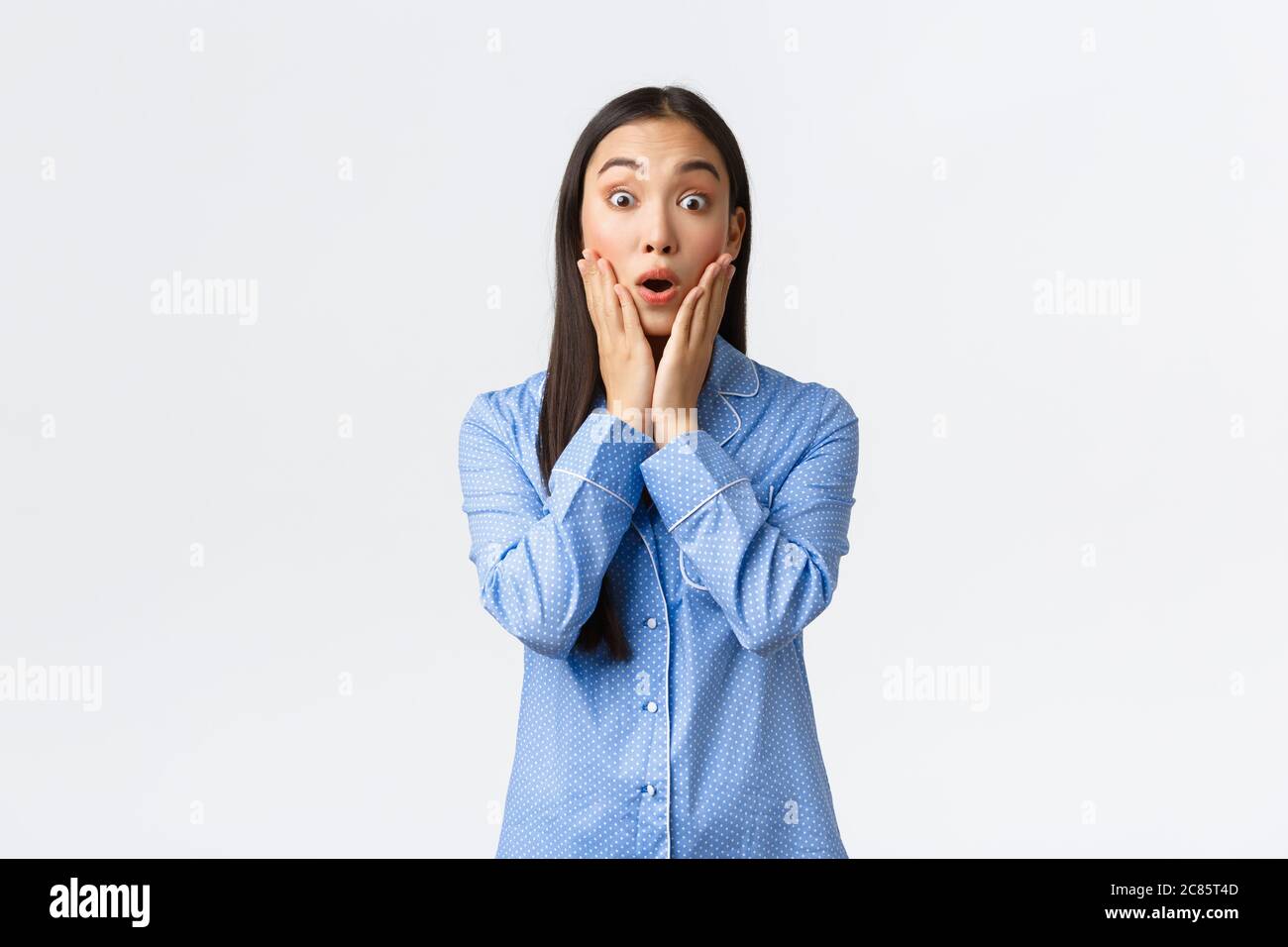 Surprised and astounded beautiful asian girl react to wonderful ...