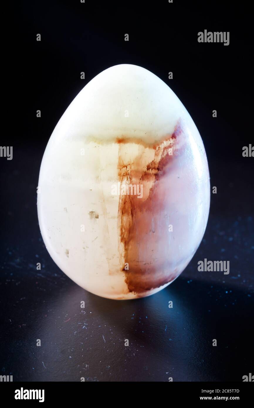Decorative marble egg in a darkness Stock Photo - Alamy