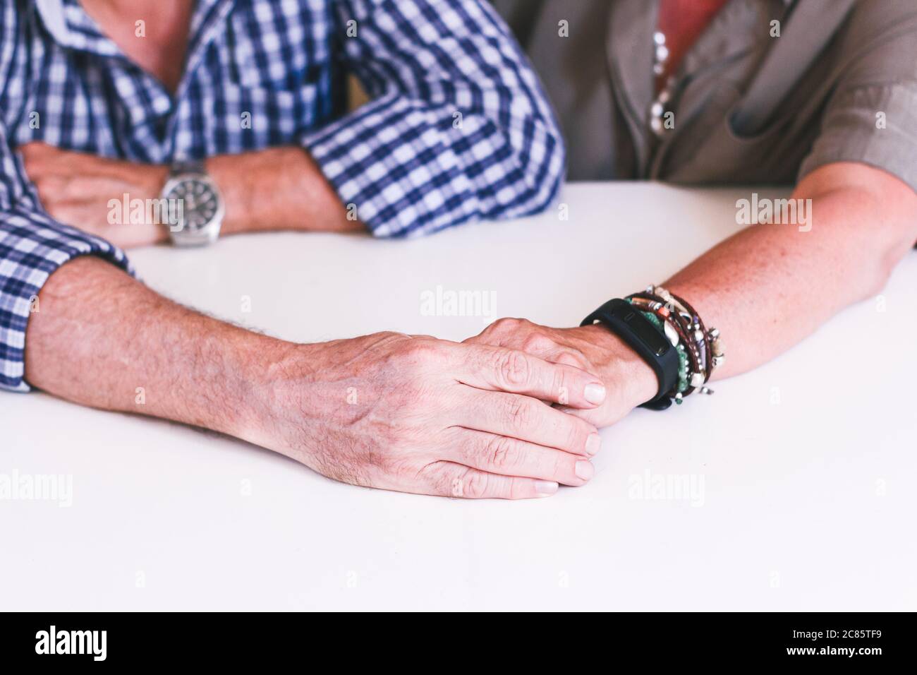 Older couple's hands caressing each other. Woman's hand with bracelets ...