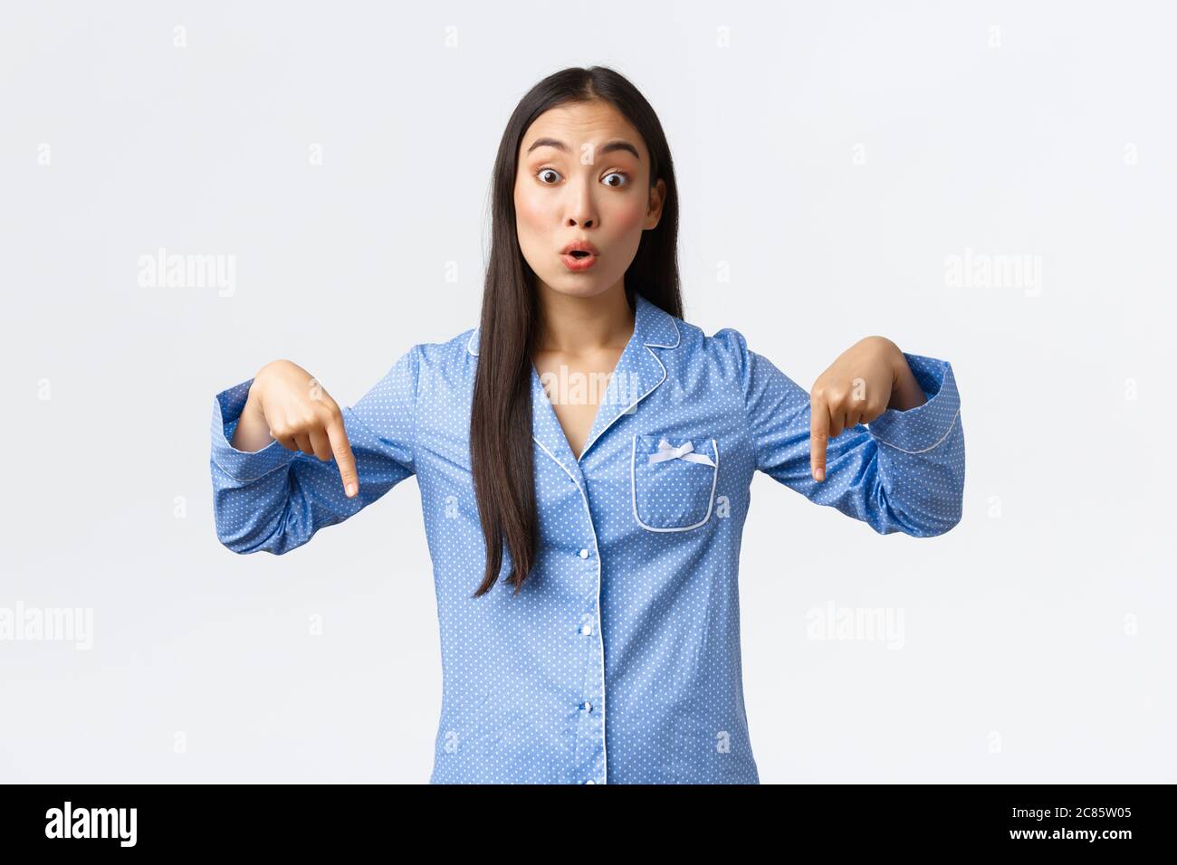 Surprised and curious beautiful korean girl in blue pajamas asking ...