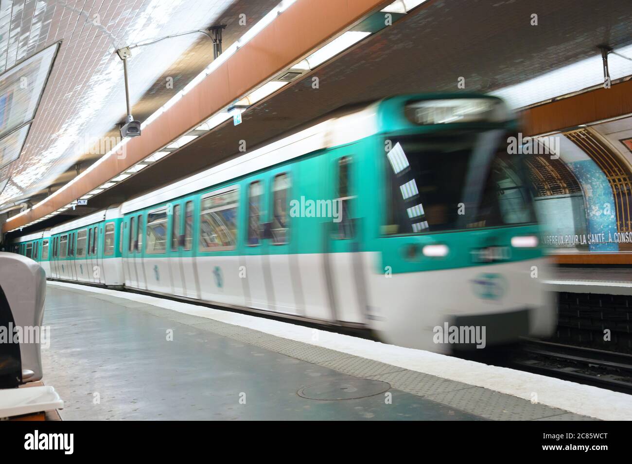 Subway station in Paris, France. A train is arriving to the stop Stock ...