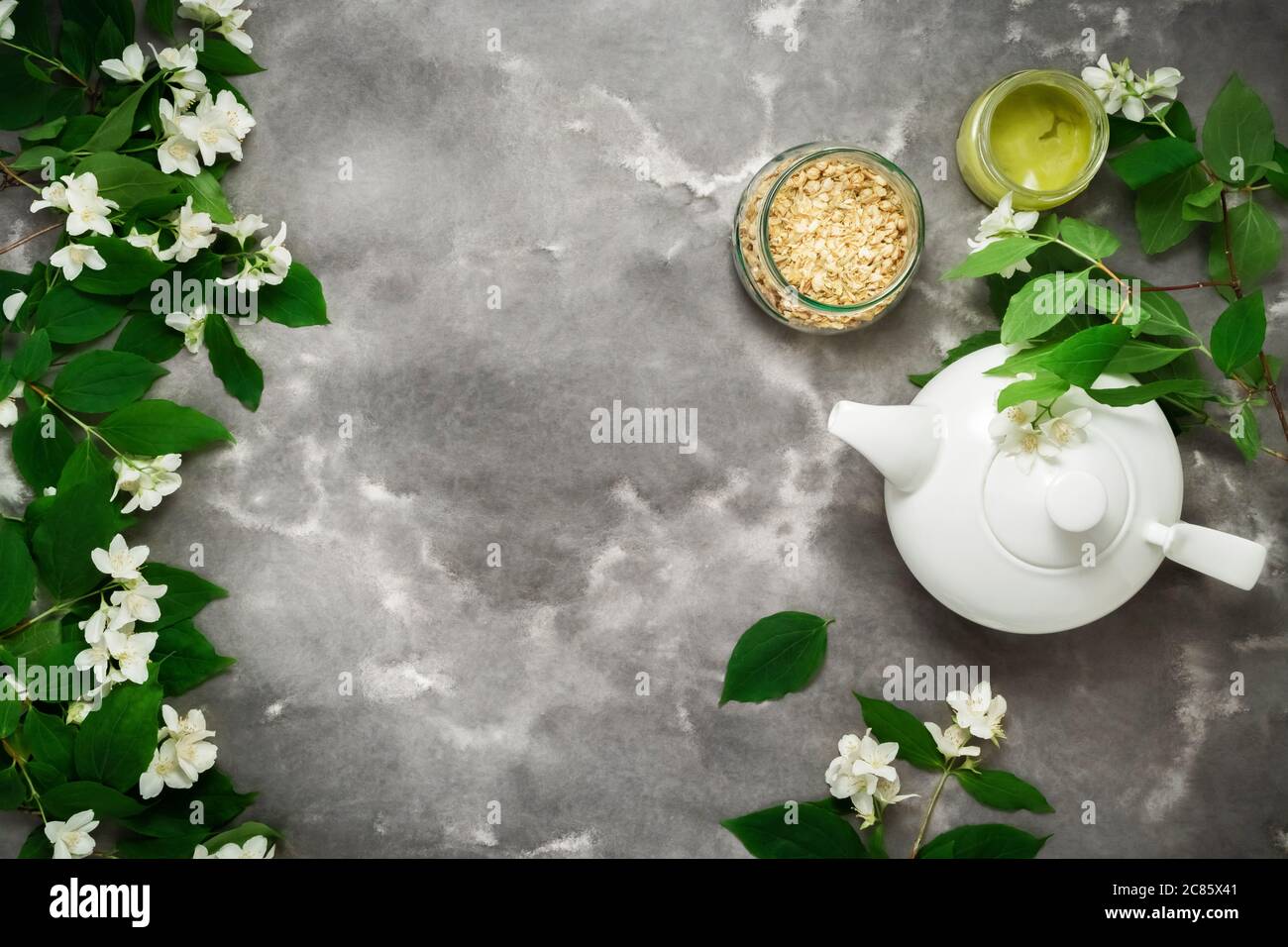 White tea pot, herbal dry tea, jasmin blossom, black white marble flat ...