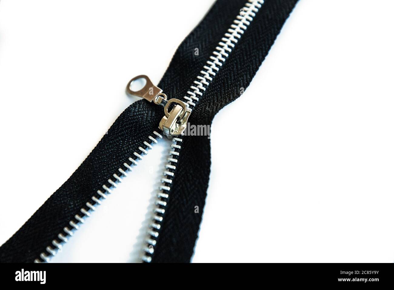 One open zipper isolated on white background, closeup Stock Photo - Alamy