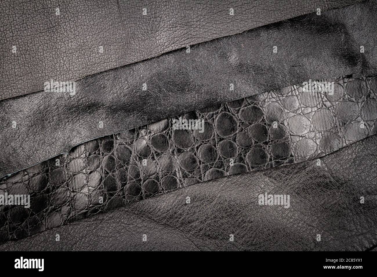 Black leather and fake artificial alligator skin textures background ...