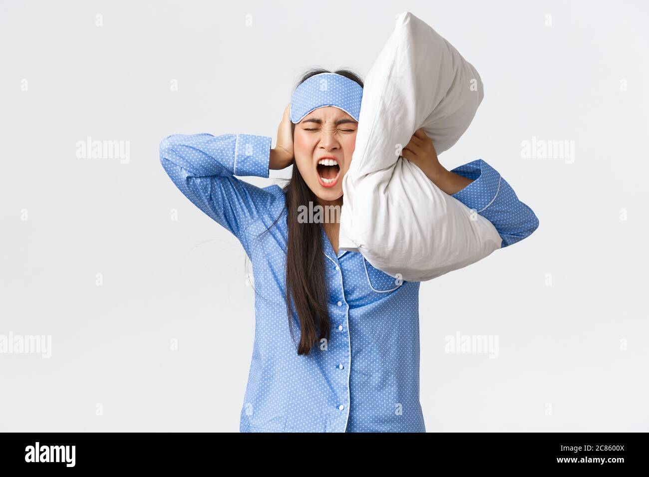 Angry furious asian girl in pajamas and sleeping mask, lying bed and ...