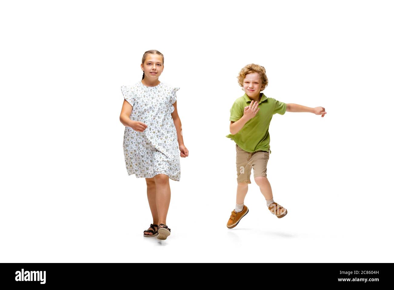 Happy children, little and emotional caucasian girl and boy jumping and ...