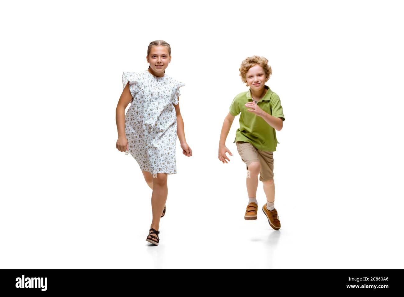 Happy children, little and emotional caucasian girl and boy jumping and ...