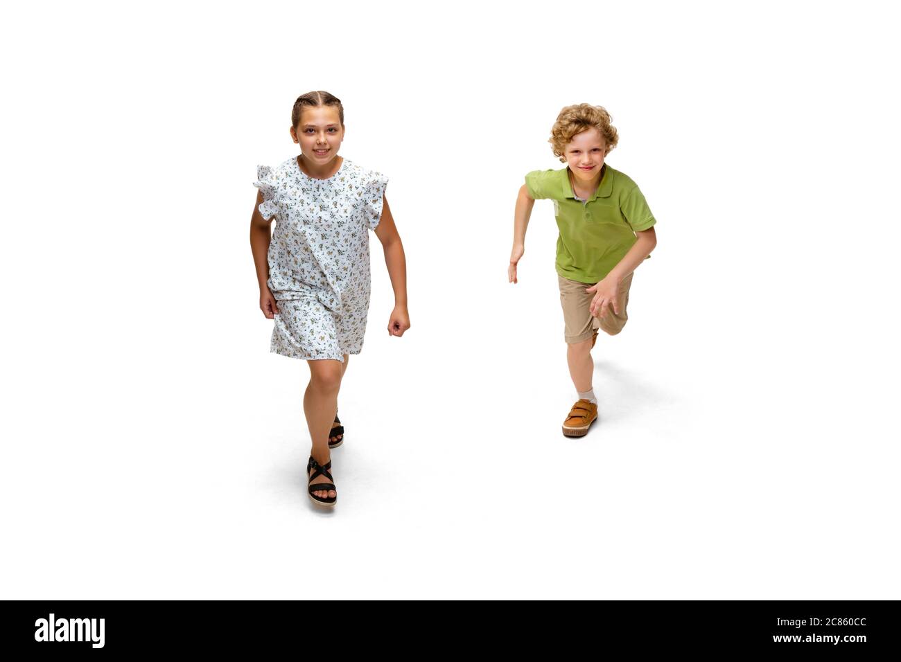 Happy children, little and emotional caucasian girl and boy jumping and ...
