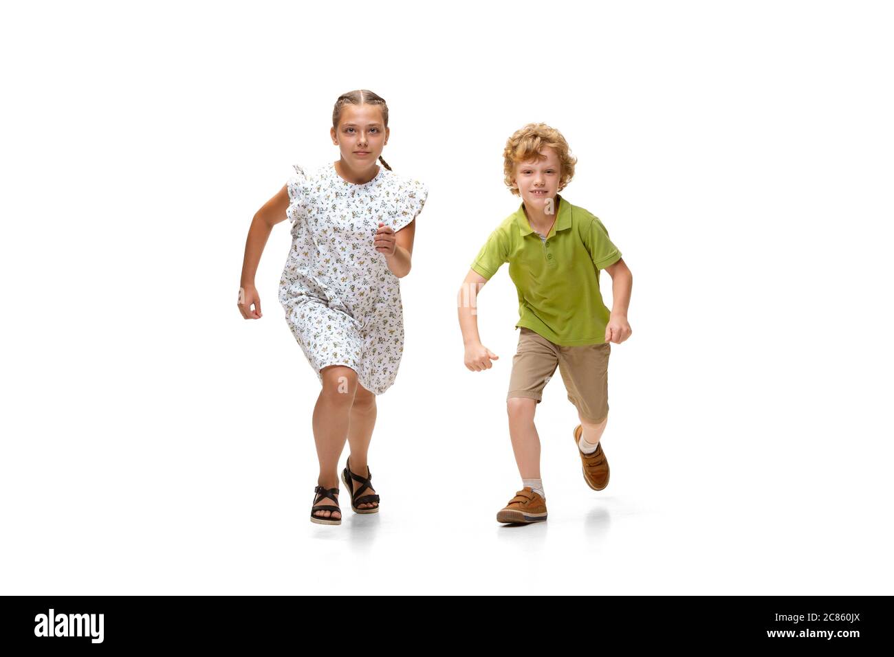 Happy children, little and emotional caucasian girl and boy jumping and ...