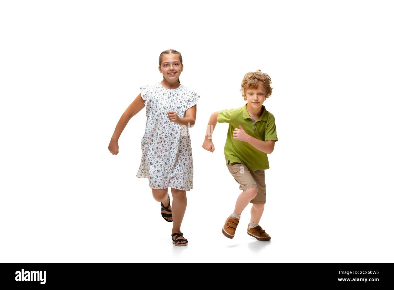 Happy children, little and emotional caucasian girl and boy jumping and ...