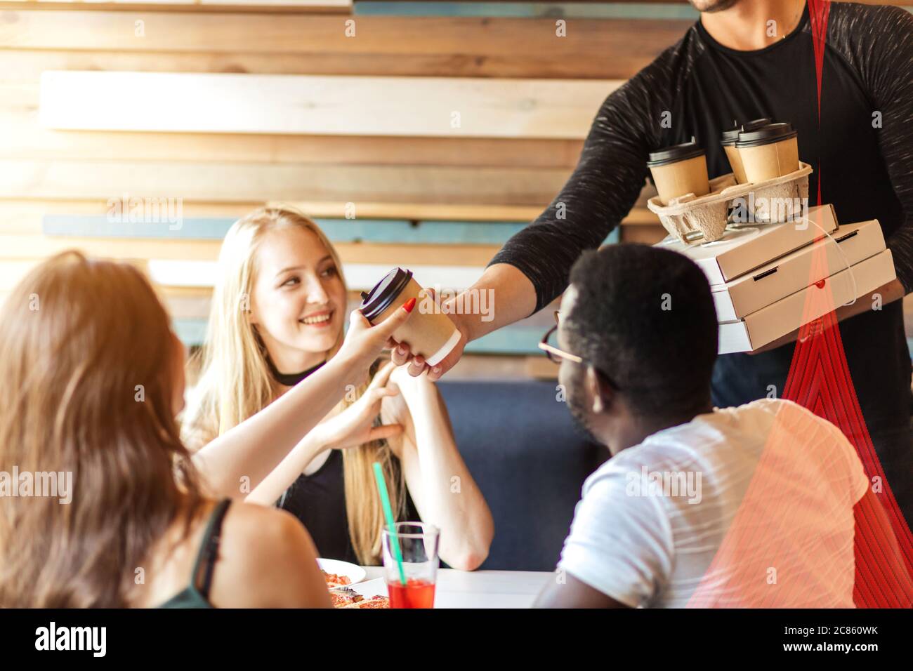 Caucasian sportive man with athletic body handing out food orders to ...